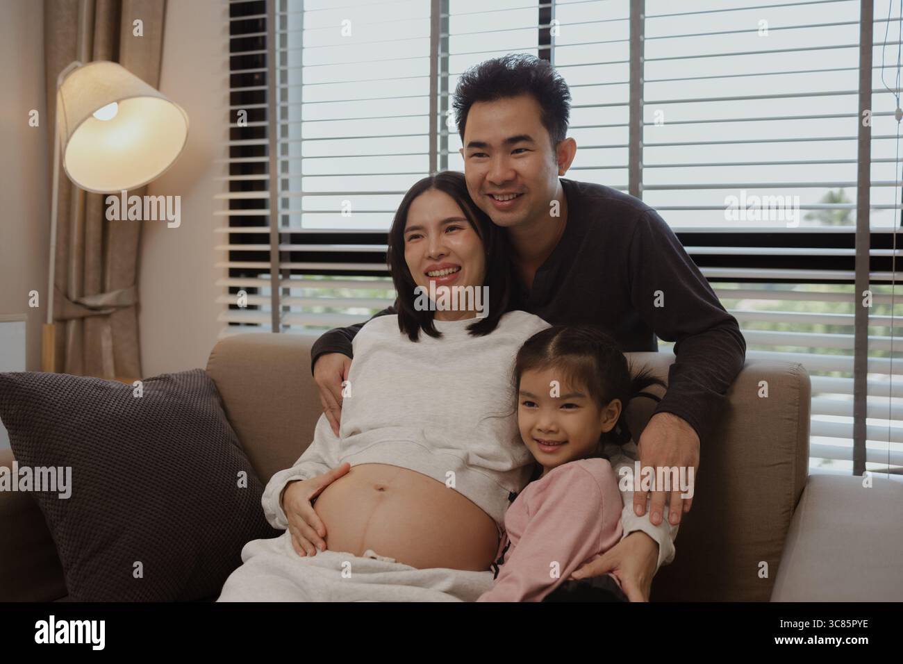 lovely family spend time together in their house, a pregnant mother ...