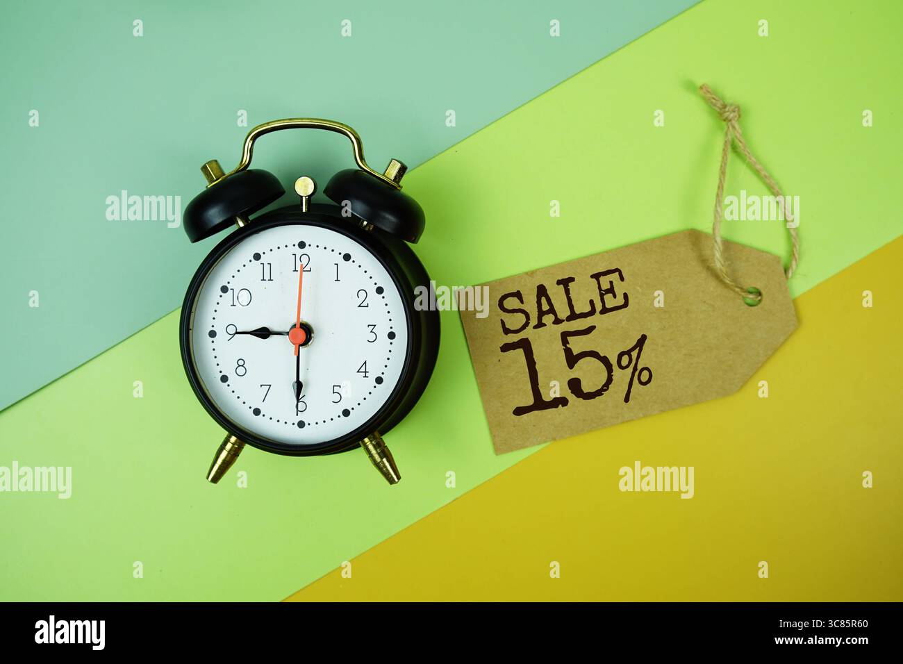 Sale 15% text on price tag with alarm clock and trolley shopping cart ...