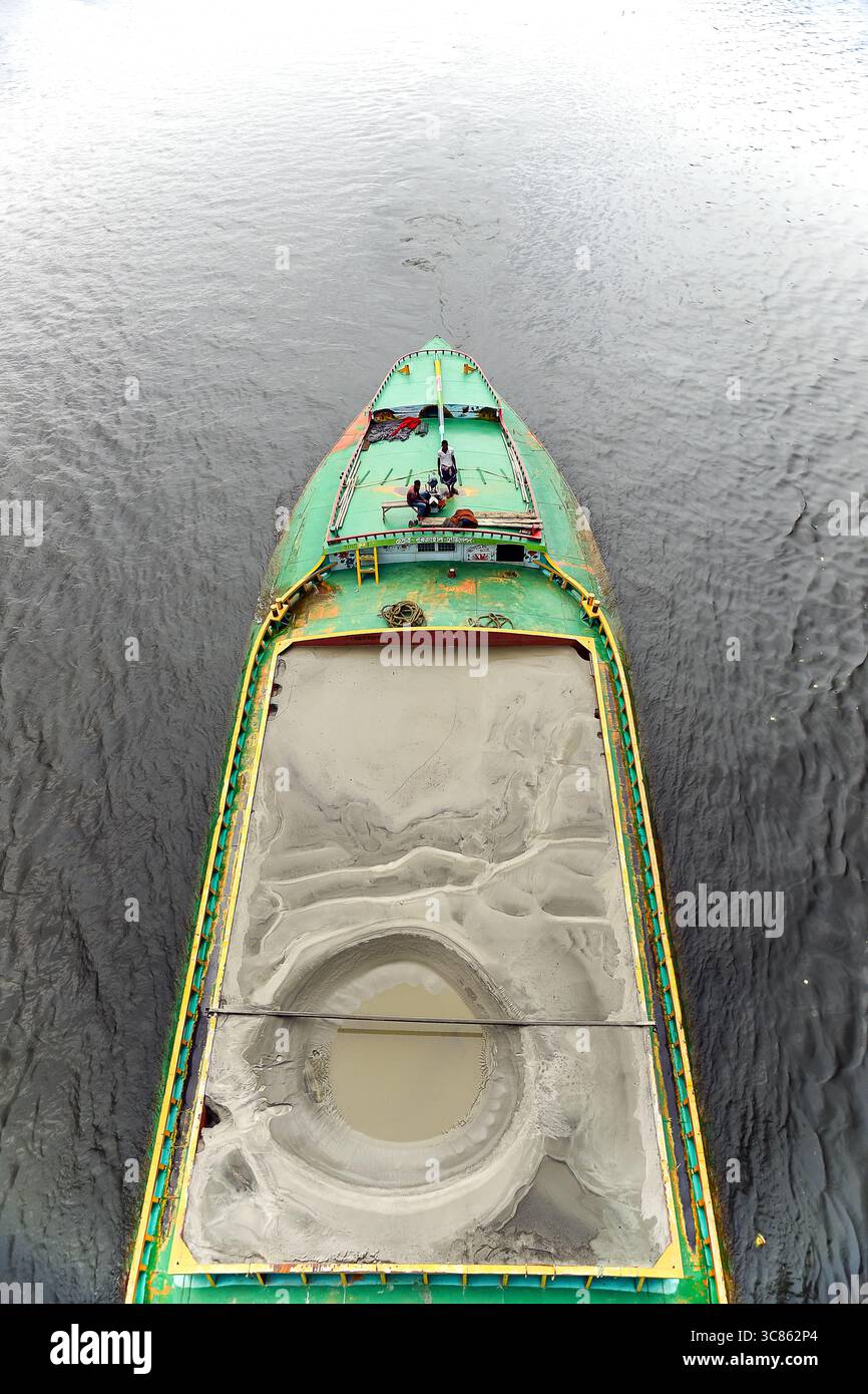 Aerial top-down view of a sand-laden cargo ship with crew on deck ...