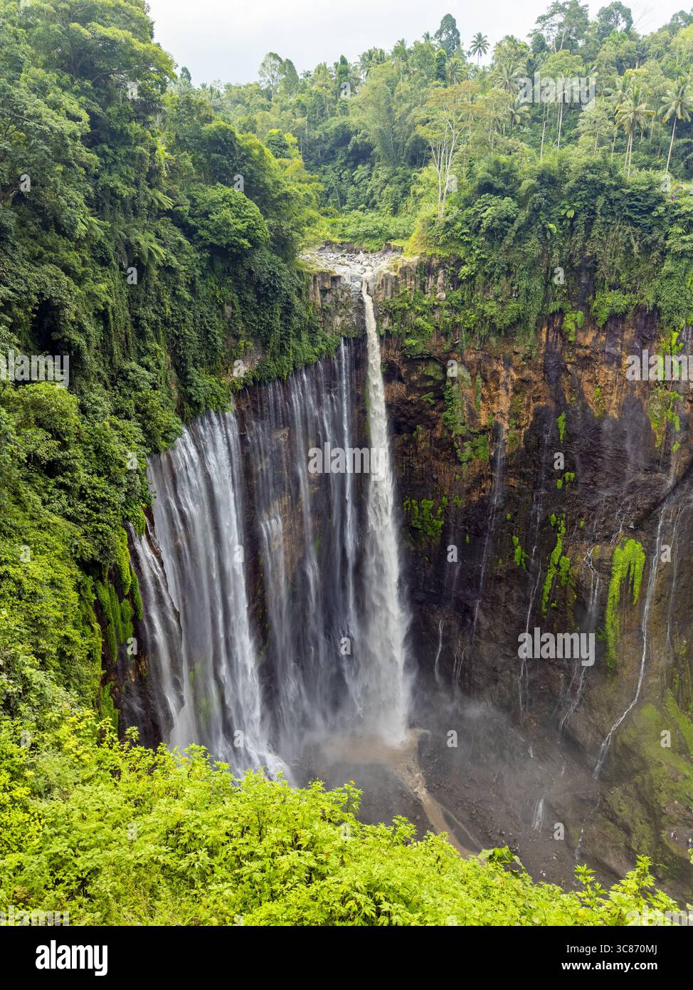 Aerial view of the majestic Tumpak Sewu waterfall cascading down the ...