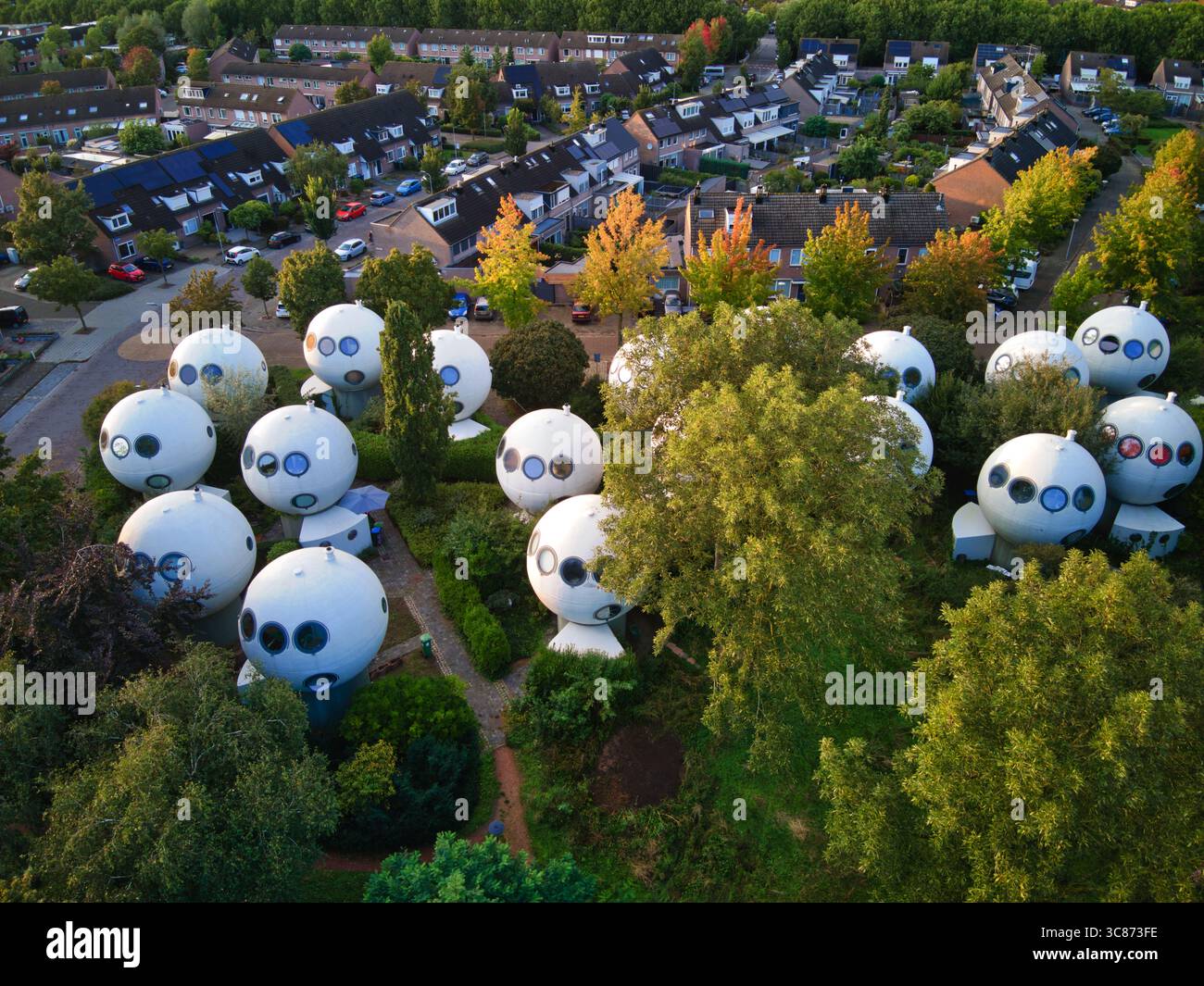 Aerial view of futuristic white sphere houses nestled amongst lush ...