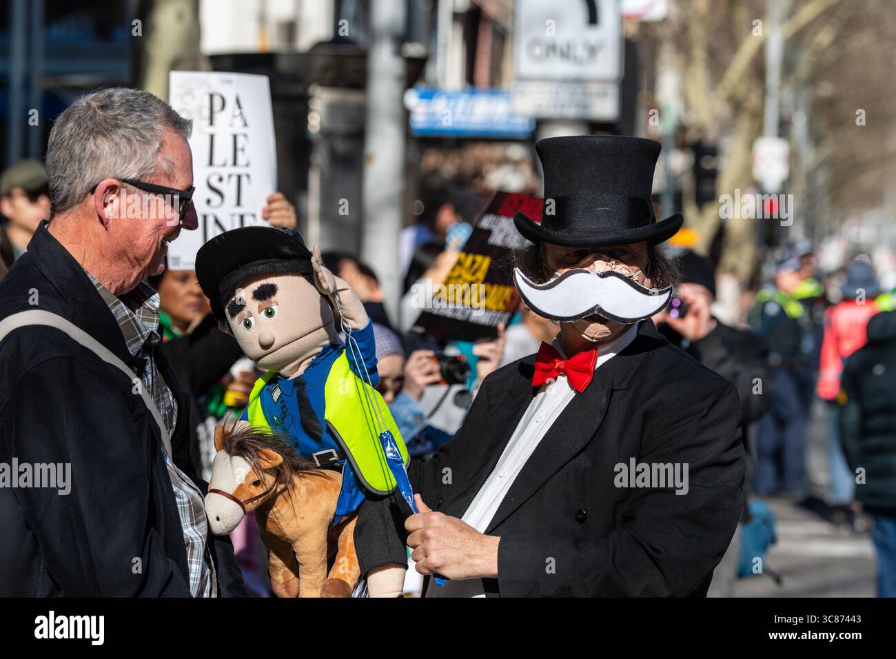 A demonstrator performs street theatre while dressed as the Monopoly ...