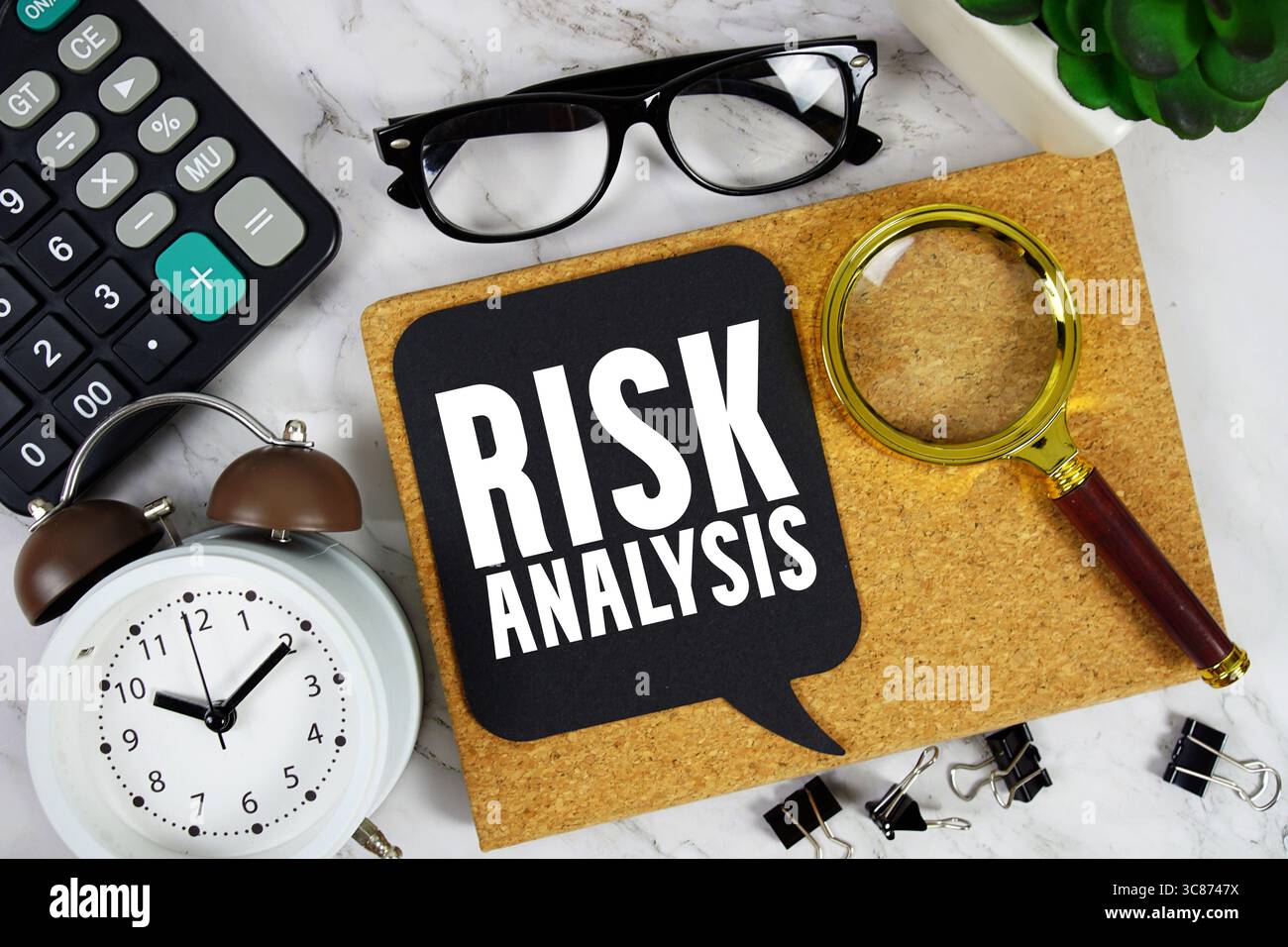 Risk Analysis text with Calculator, alarm clock and magnifying glass on ...