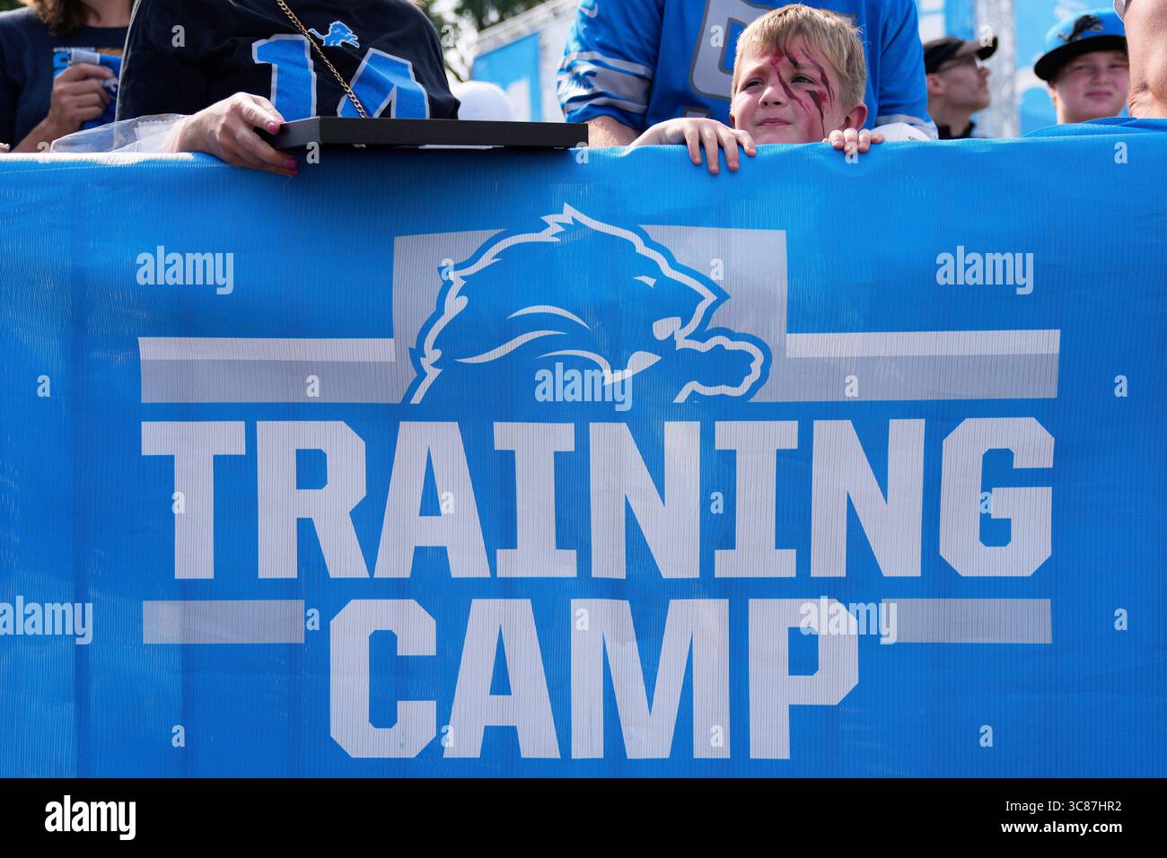 Fans wait for players to sign autographs during NFL football training ...