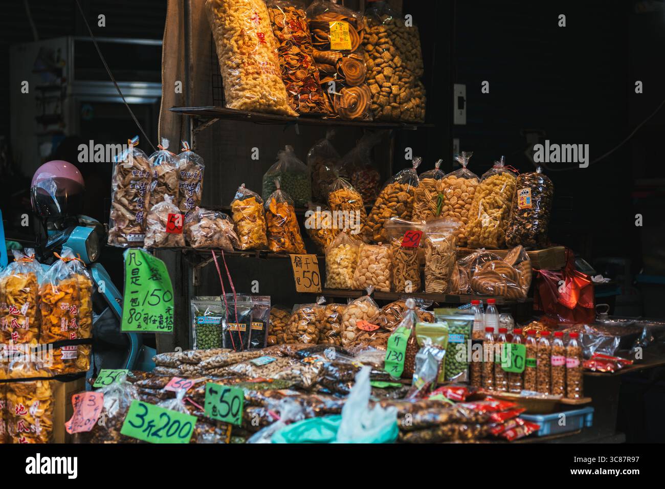 Traditional snack stall in Taiwanese street market with various ...