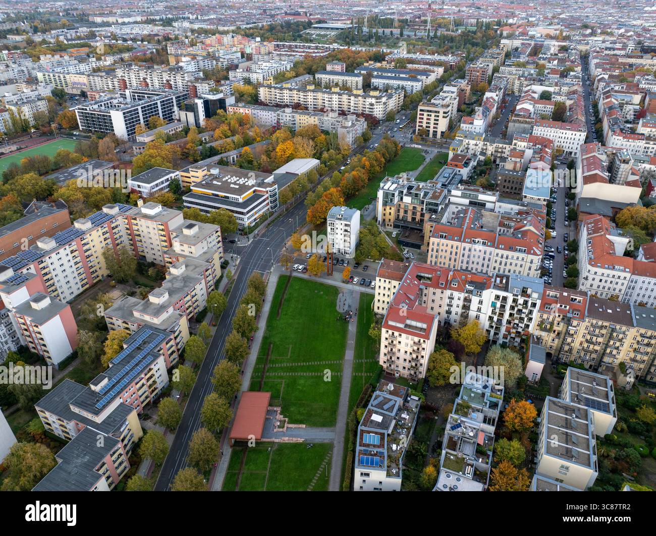 Aerial view of buildings scattered among parks and roads, with a blend ...
