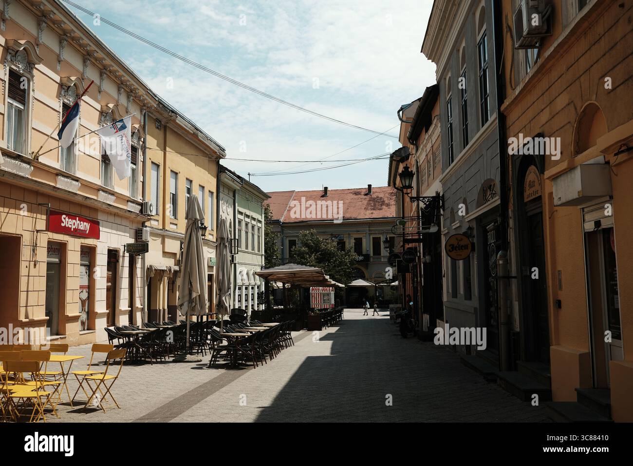 Cozy pedestrian street with outdoor cafes, old buildings and ...