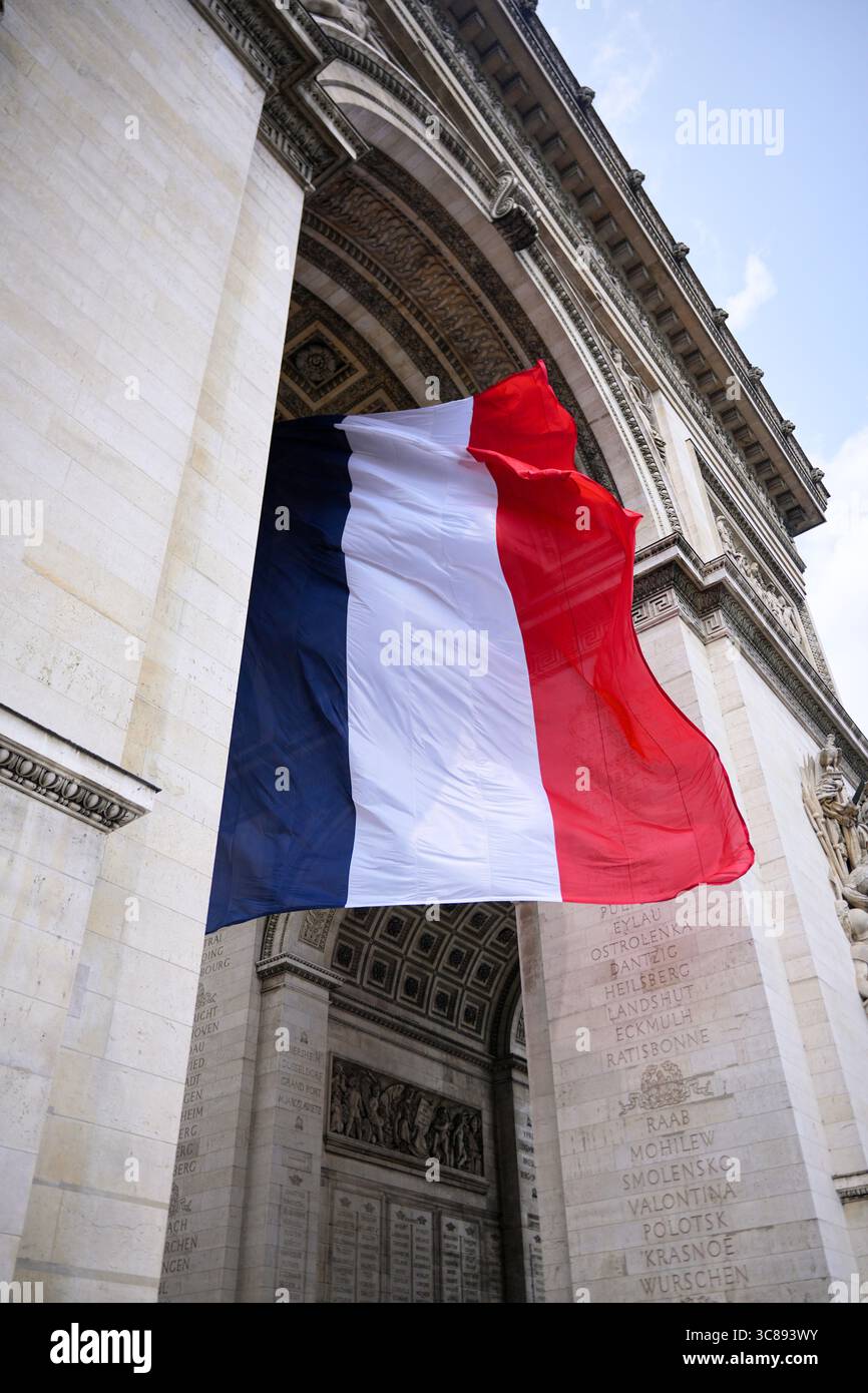 French national flag under Arc de Triomphe arch in Paris Stock Photo ...