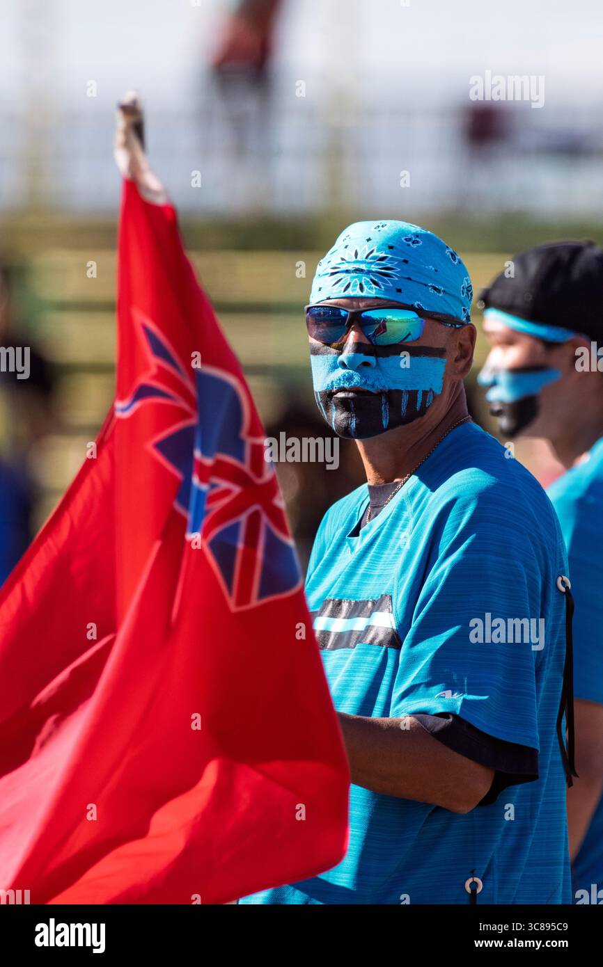 Team flag bearer at the opening ceremony, Blackfoot First Nations Indian Relay (horse) race ...