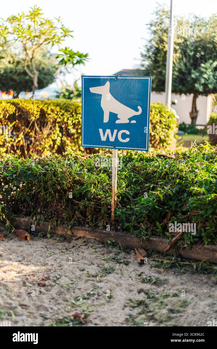 A blue sign features a dog icon with the letters WC, marking a specific ...