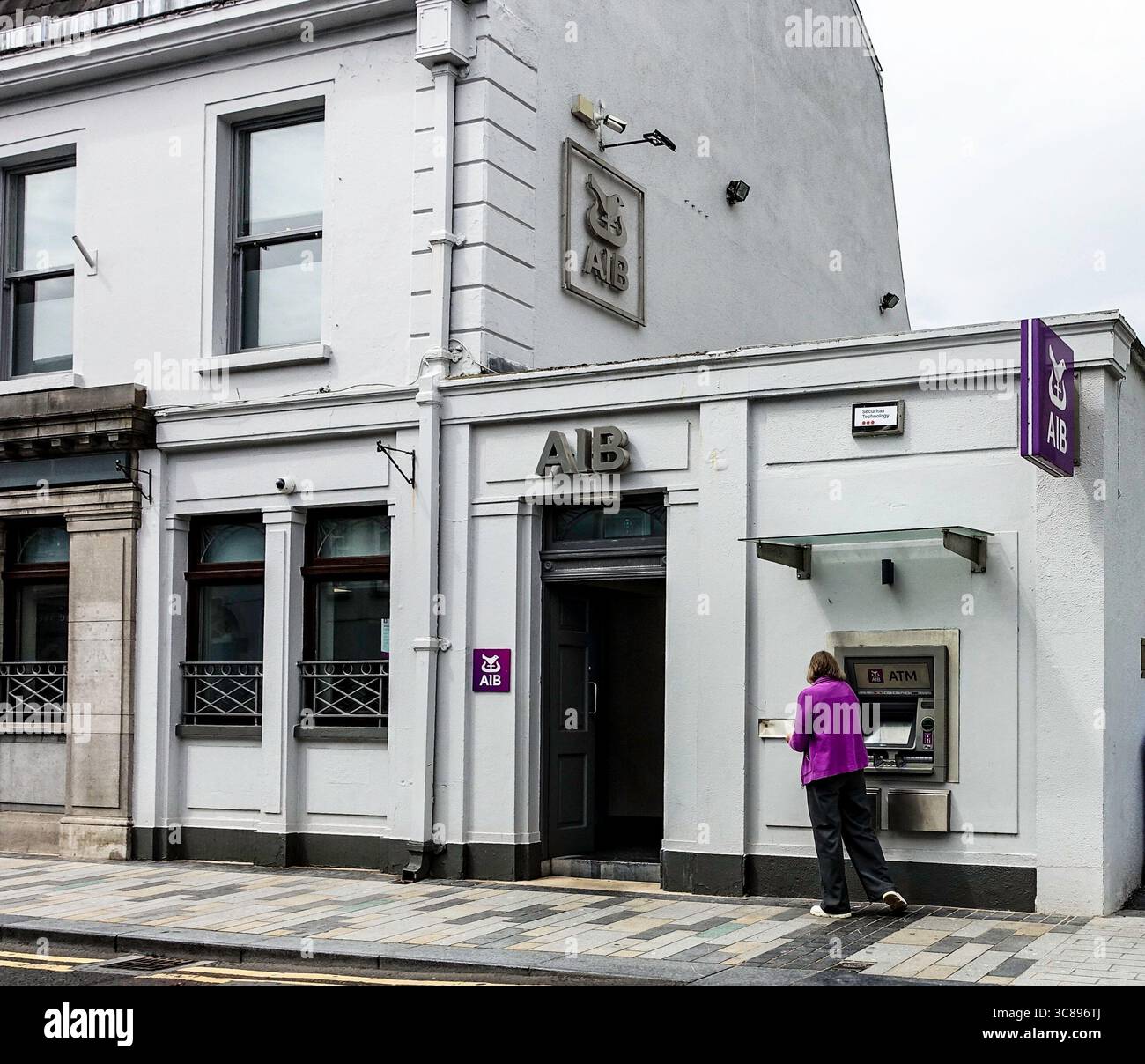 Woman using ATM outside AIB bank branch in Carrick-on-Shannon, County ...