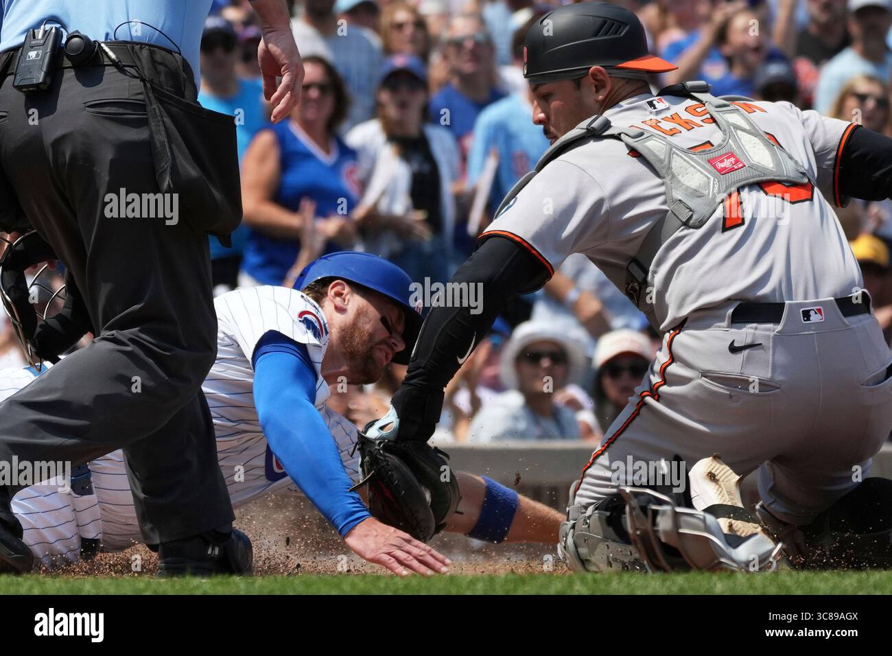 Chicago Cubs' Carson Kelly, left, is tagged out by Baltimore Orioles ...