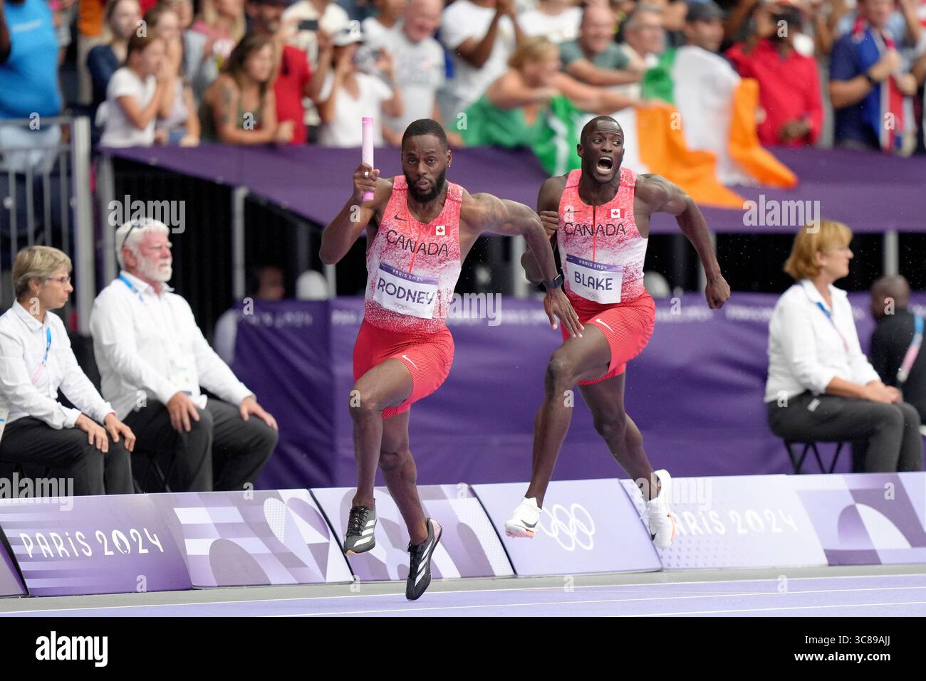Canada's Jerome Blake cheers as teammate Brendon Rodney runs the baton ...