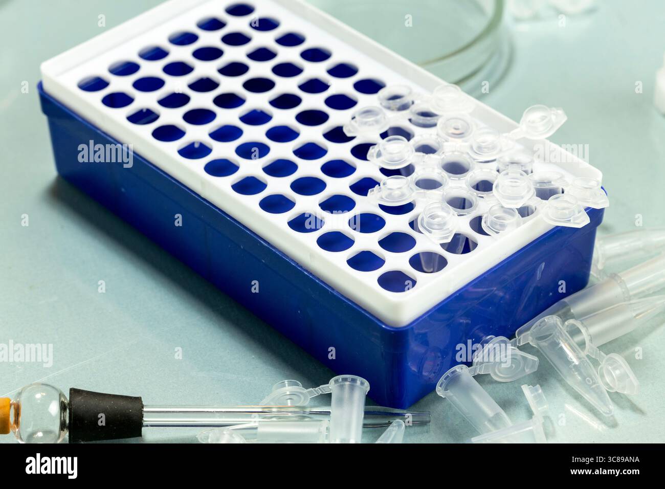 Laboratory equipment including a blue box with multiple test tubes and ...