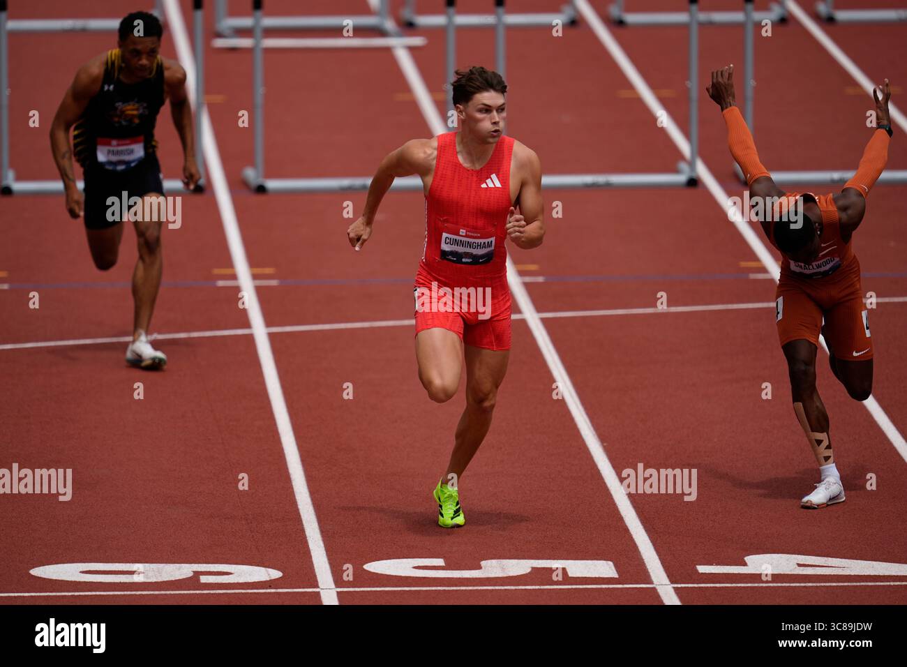 Trey Cunningham, center, wins the third heat in the men's 110-meter ...