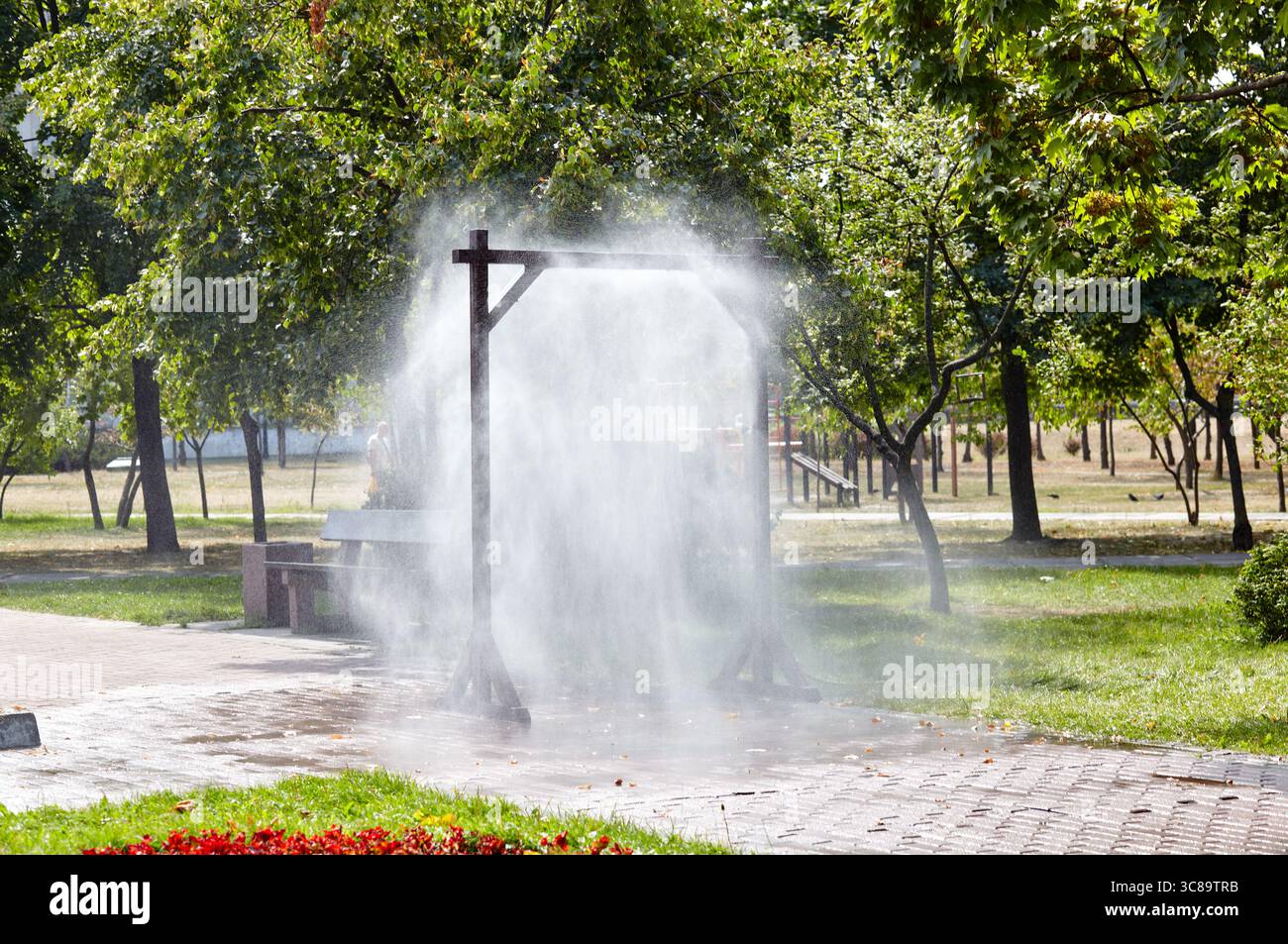 Water spray frame for cooling in hot weather on city street in Kyiv, Ukraine. Water mist cooling ...