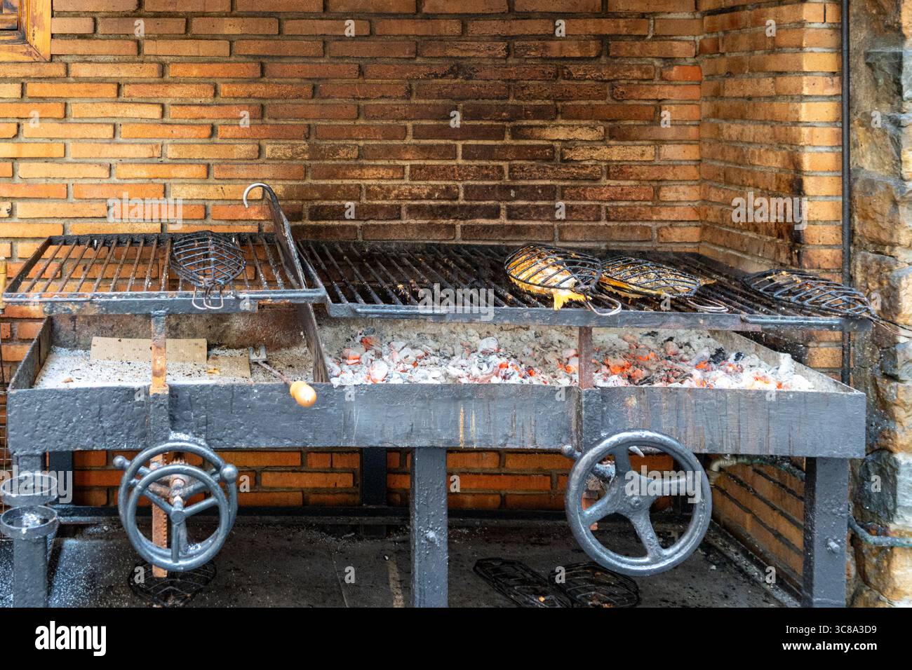 A traditional charcoal grill featuring metal grates and decorative ...