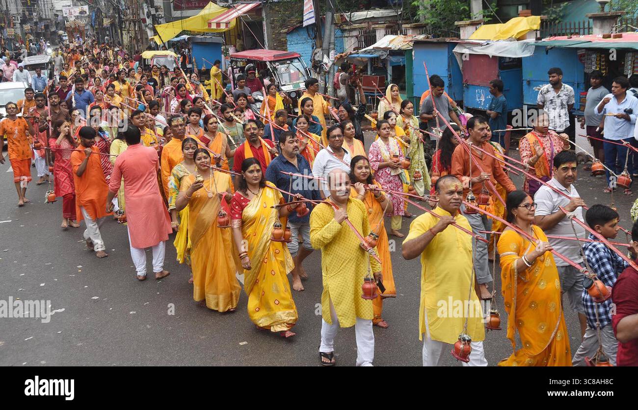 PATNA, INDIA - AUGUST 3: People carry holy water of the Ganga river ...