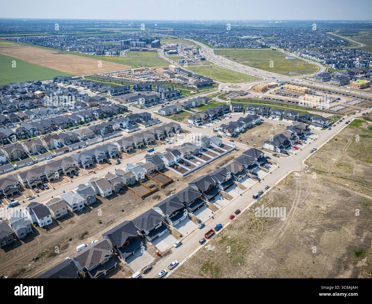 Residential area with many houses and a few cars. The houses are mostly ...