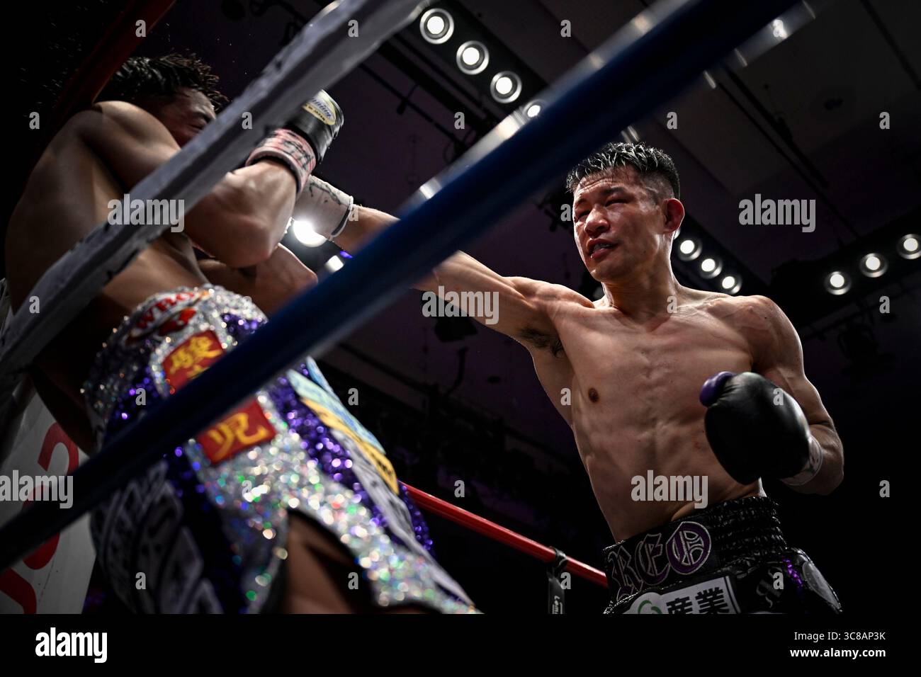 Champion Kai Watanabe (L) and challenger Reo Saito compete during their ...