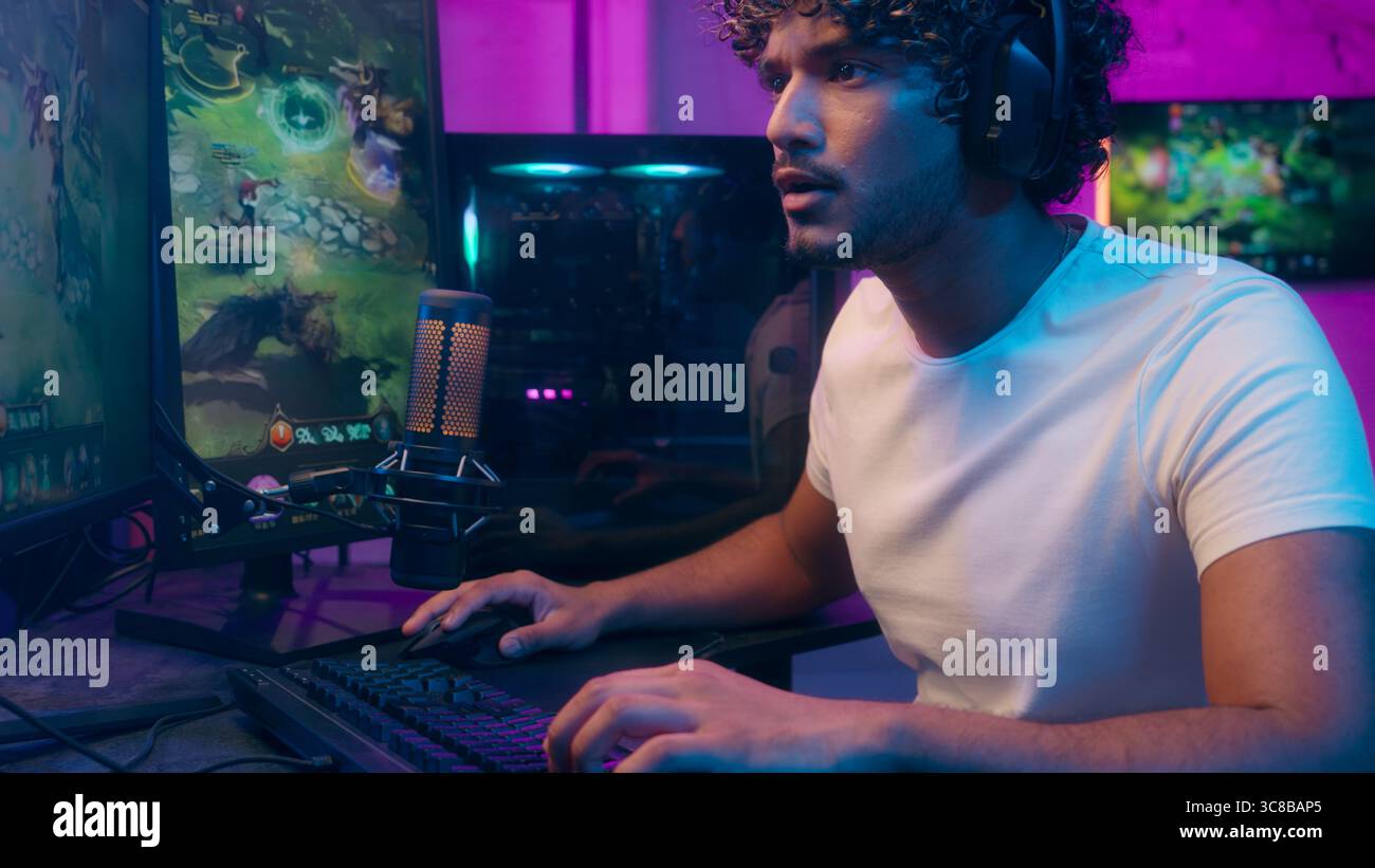 Indian Arabian Latino American man play computer video game monitor ...