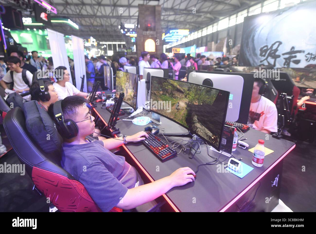 Visitors play computer games at the China Digital Entertainment Expo ...