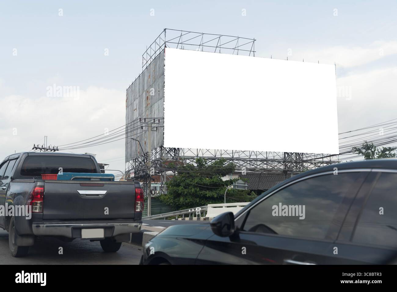 Empty white billboard for advertising on busy city street with passing ...