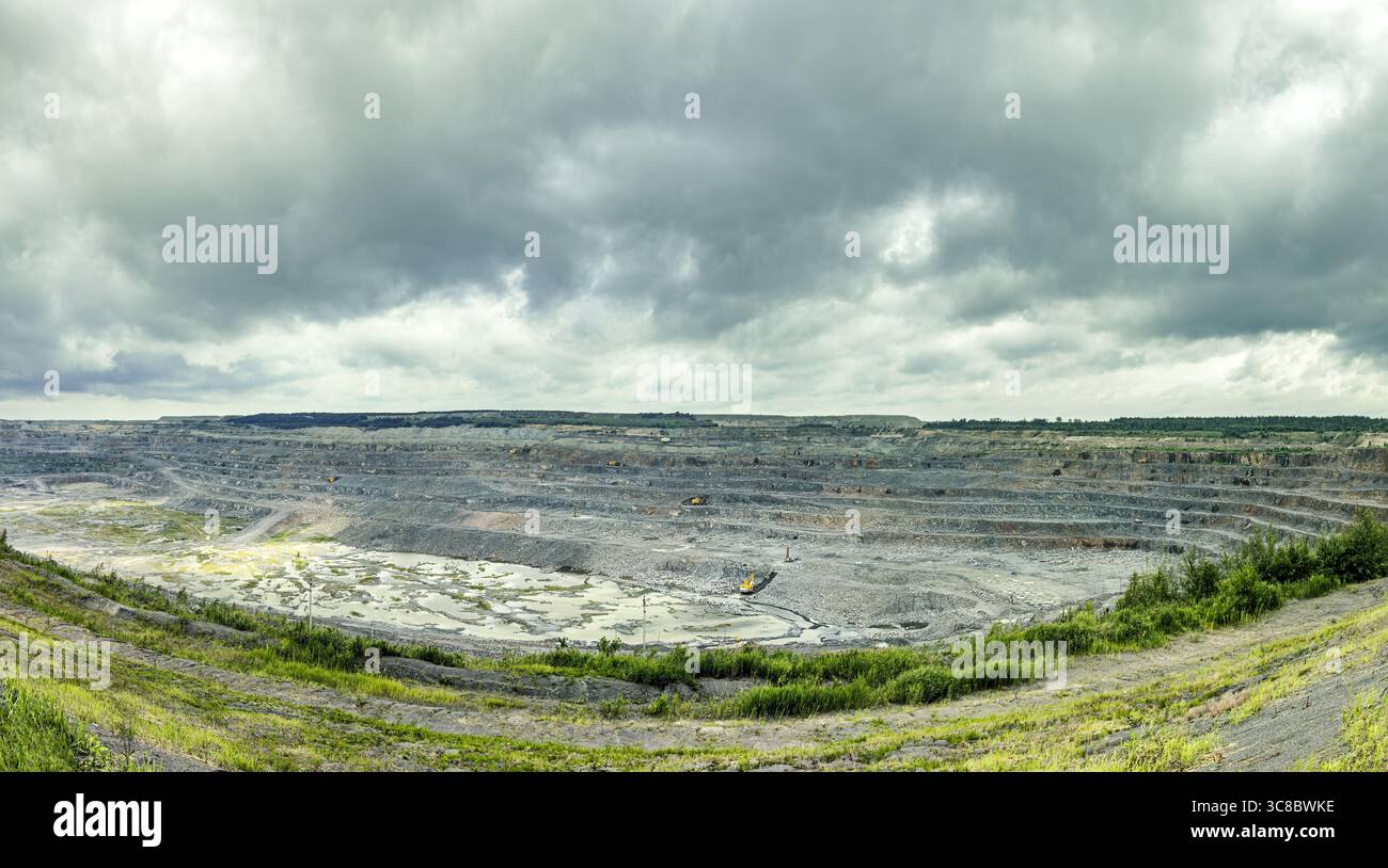 panorama of a large mining quarry for extraction of granite stone. open ...