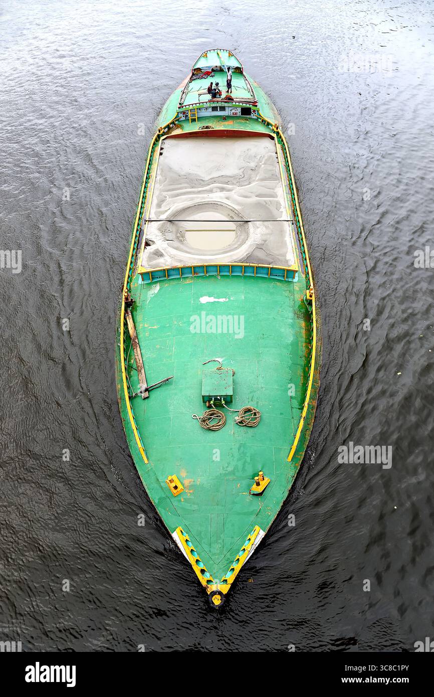 Aerial top-down view of a sand-laden cargo ship with crew on deck ...