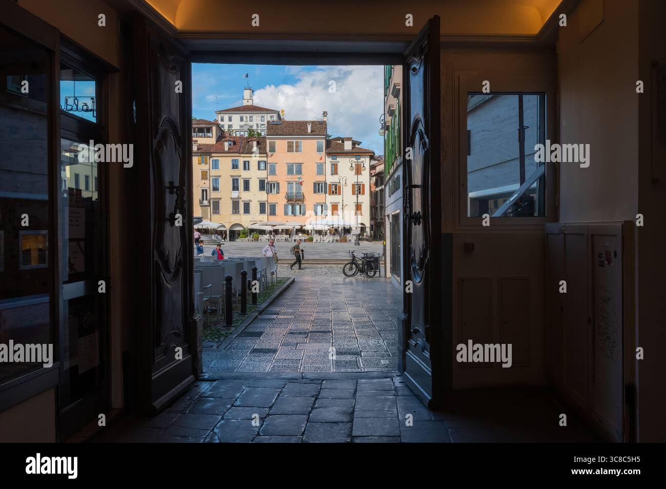 Udine, Italy (3rd August 2025) - Looking out through a large old ...