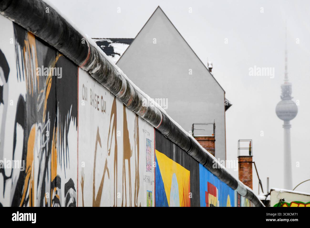 Colorful murals on the Berlin Wall at the East Side Gallery with ...