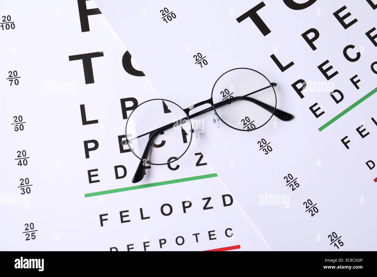 Glasses on vision test charts, top view Stock Photo - Alamy