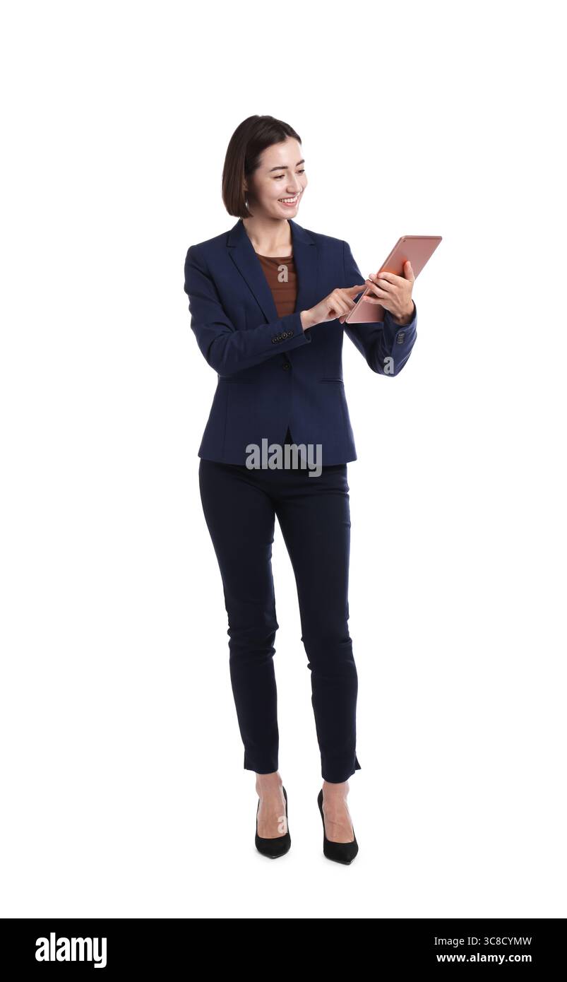 Smiling hostess in uniform using tablet on white background Stock Photo ...