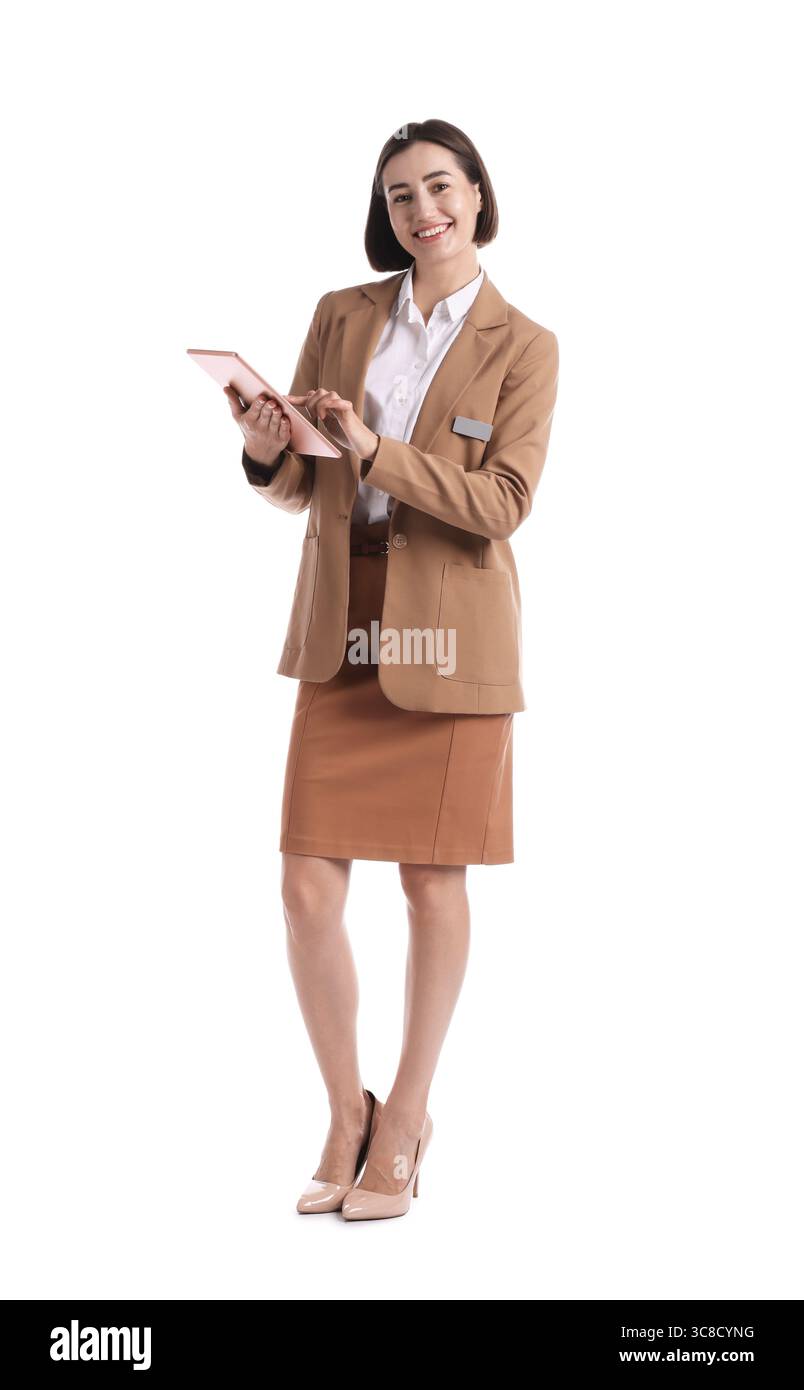 Smiling hostess in uniform using tablet on white background Stock Photo ...