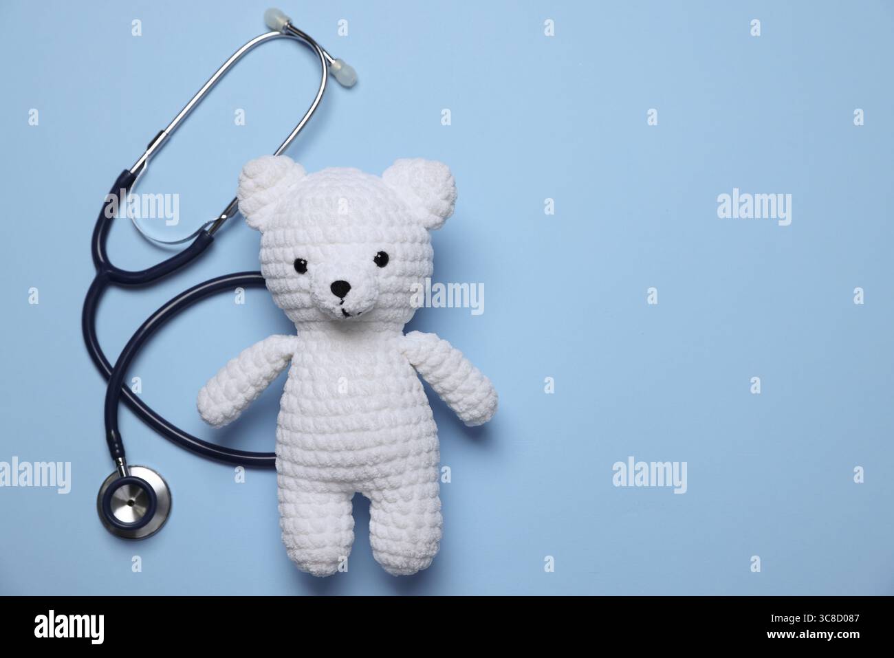 Pediatrics concept. Toy bear with stethoscope on light blue background ...