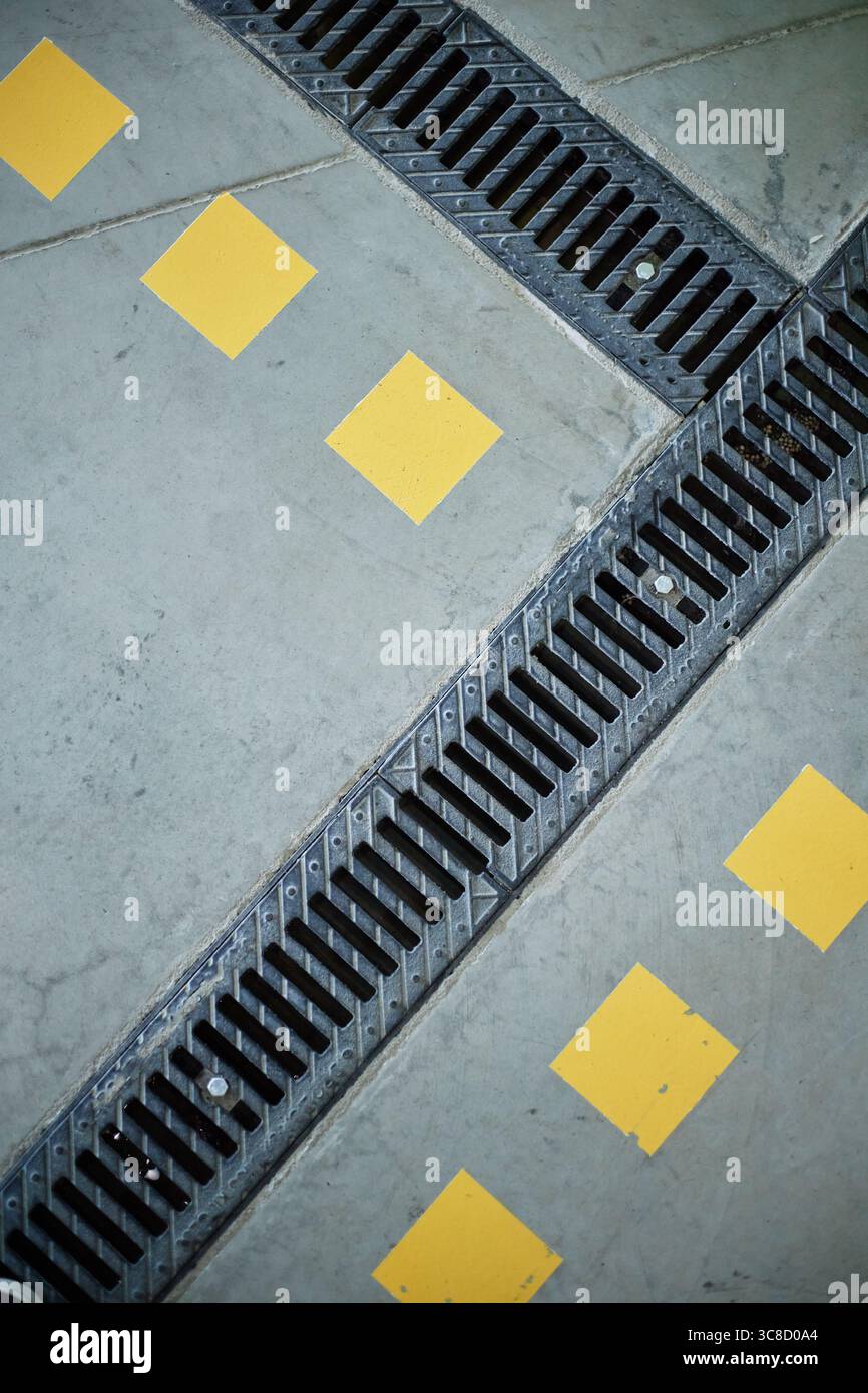 Diagonal Storm Drains Crossing Concrete Floor with Yellow Safety ...