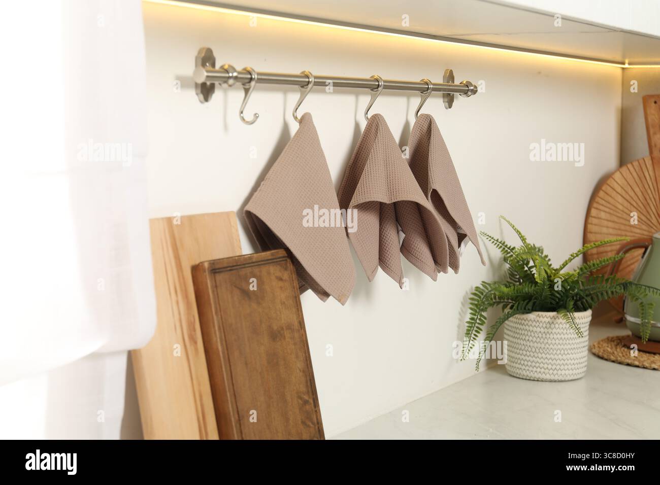 Clean waffle towels hanging on hook rack in kitchen Stock Photo - Alamy