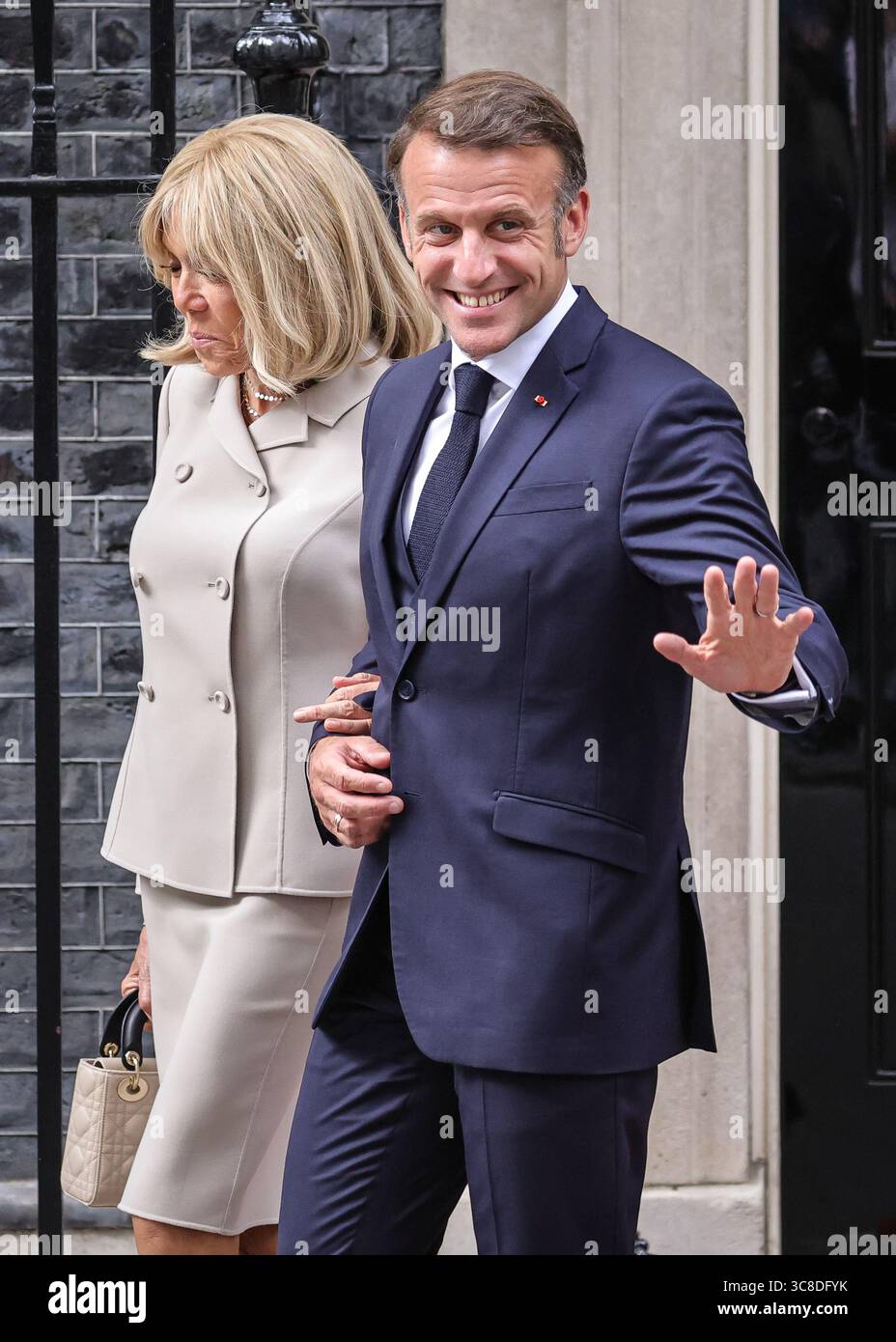President of France Emmanuel Macron and wife Brigitte wave, smile and ...