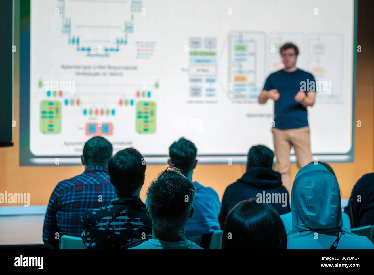 Technical expert presenting workshop to audience with diagrams ...