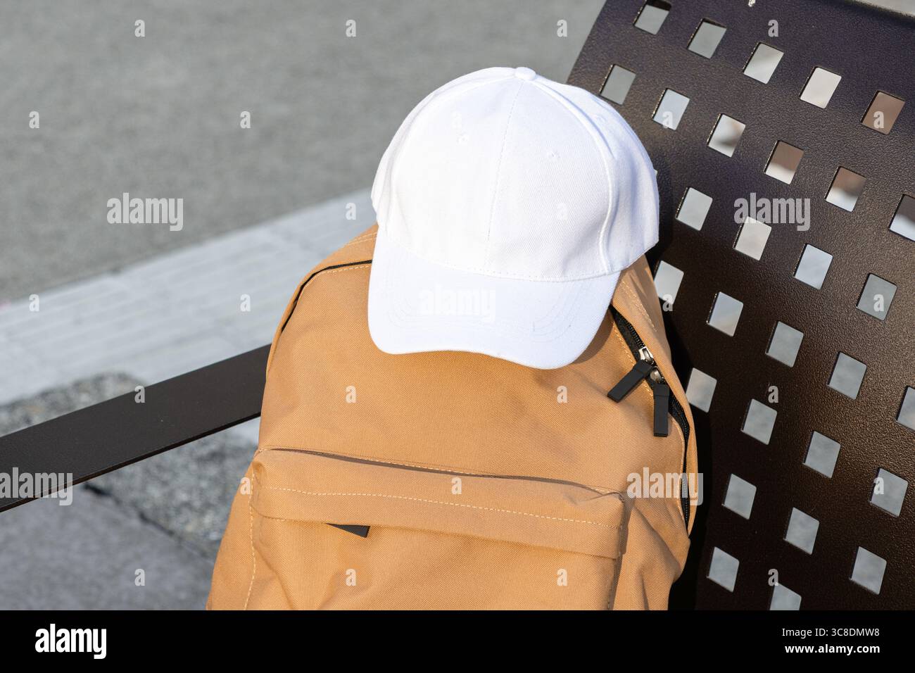 Blank white baseball cap on top of an urban backpack . Template Mock up ...