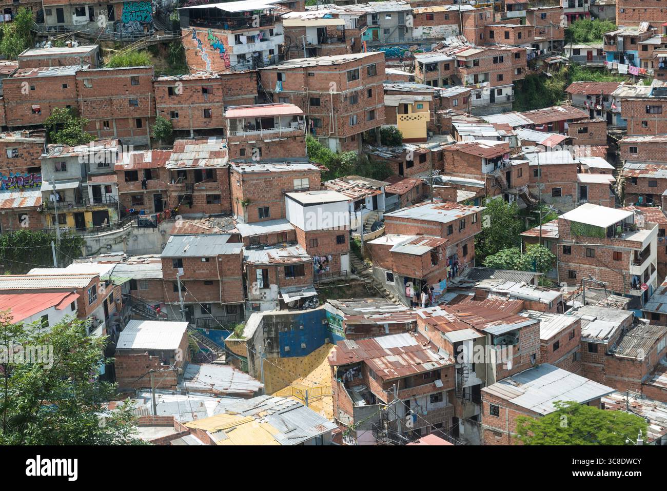Aerial view of Comuna 13 with its houses stacked together, and wrapped ...