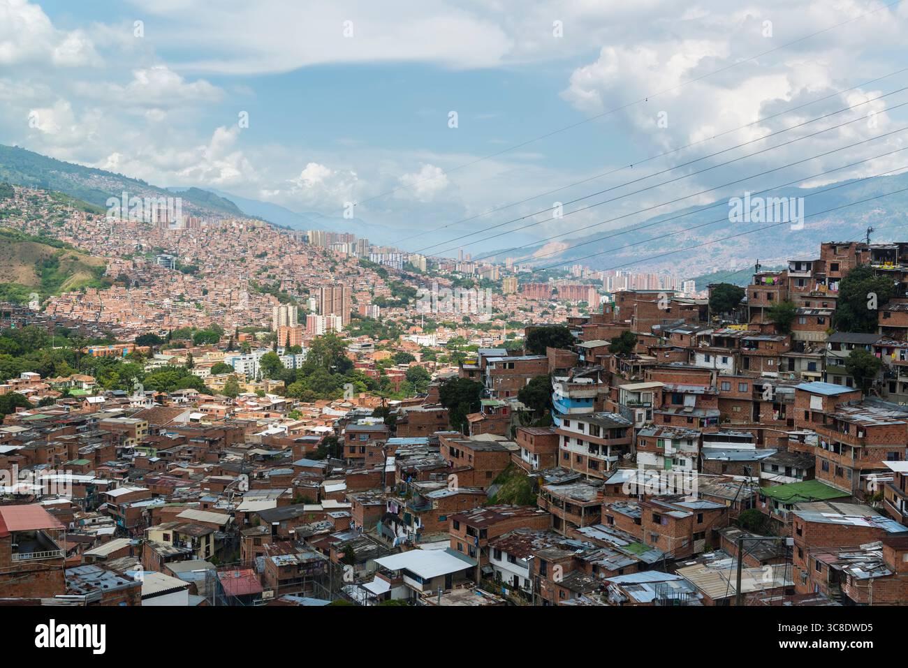Aerial view of Comuna 13 with its houses stacked together, and wrapped ...