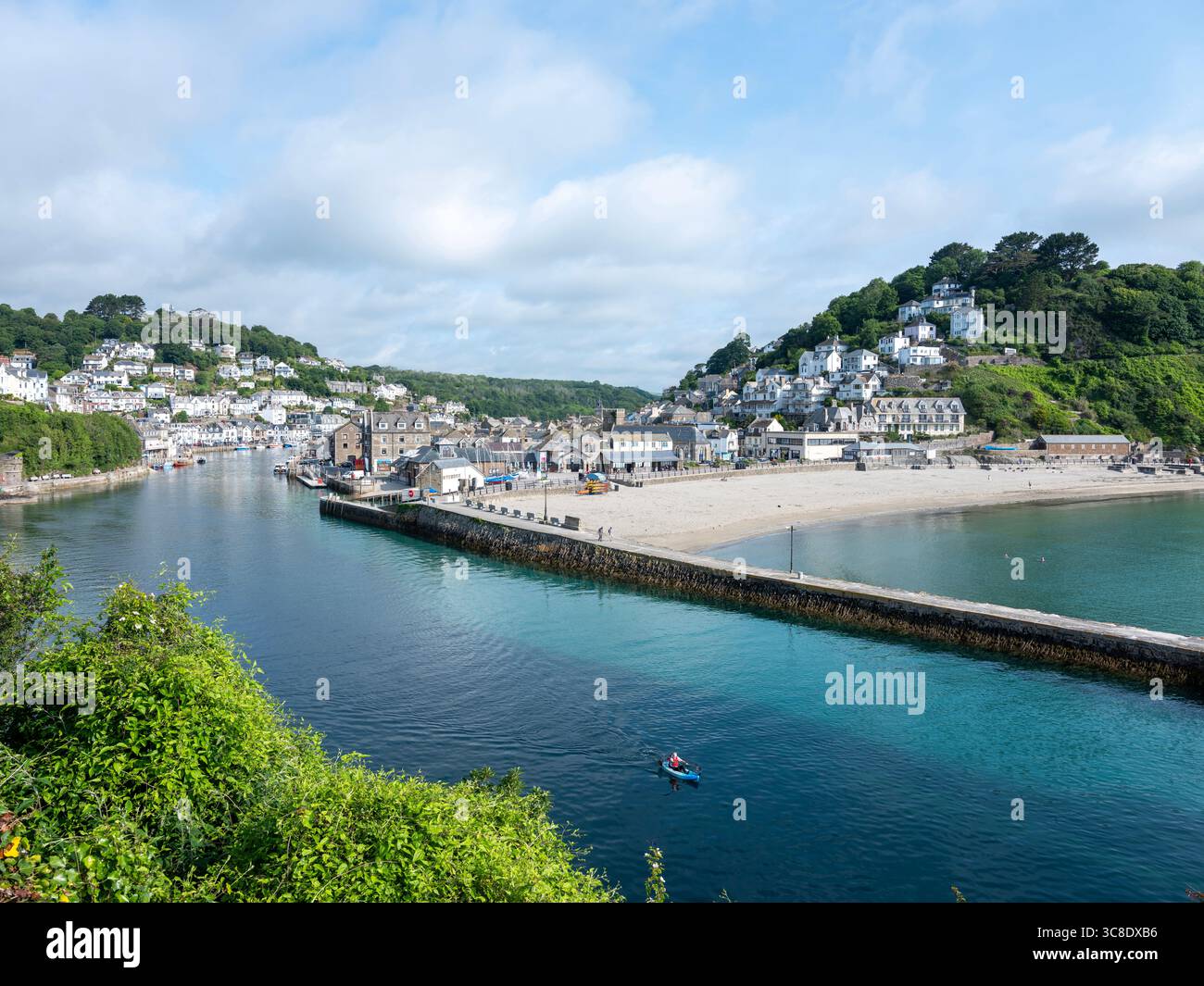 looe, UK, june 17 2025: man in canoe leaves village of looe in south ...