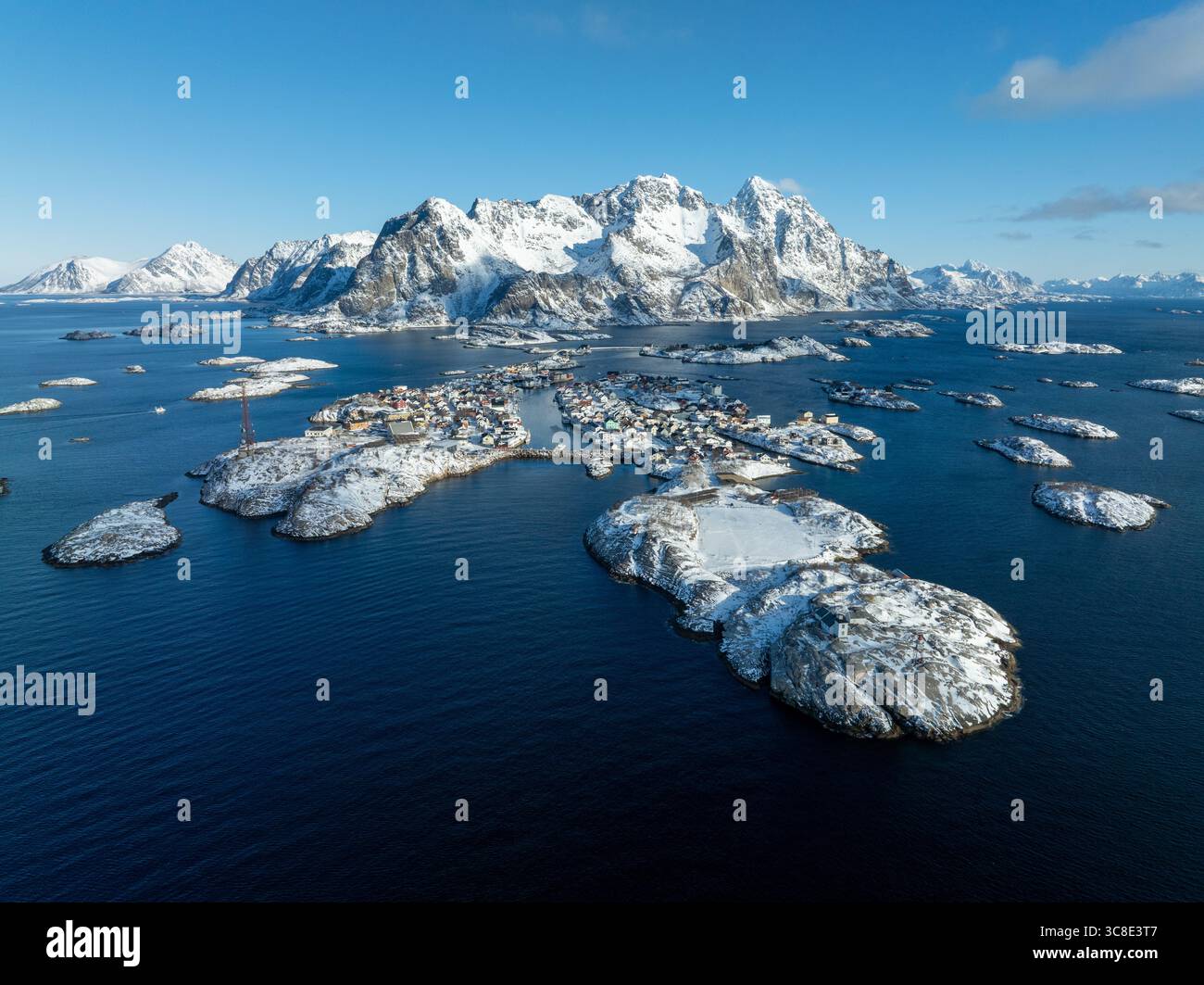 Aerial view of snow-dusted islands scattered across the sapphire sea ...
