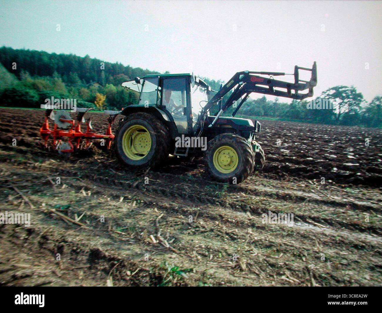 Soil cultivation and farming with a tractor in the field Soil ...