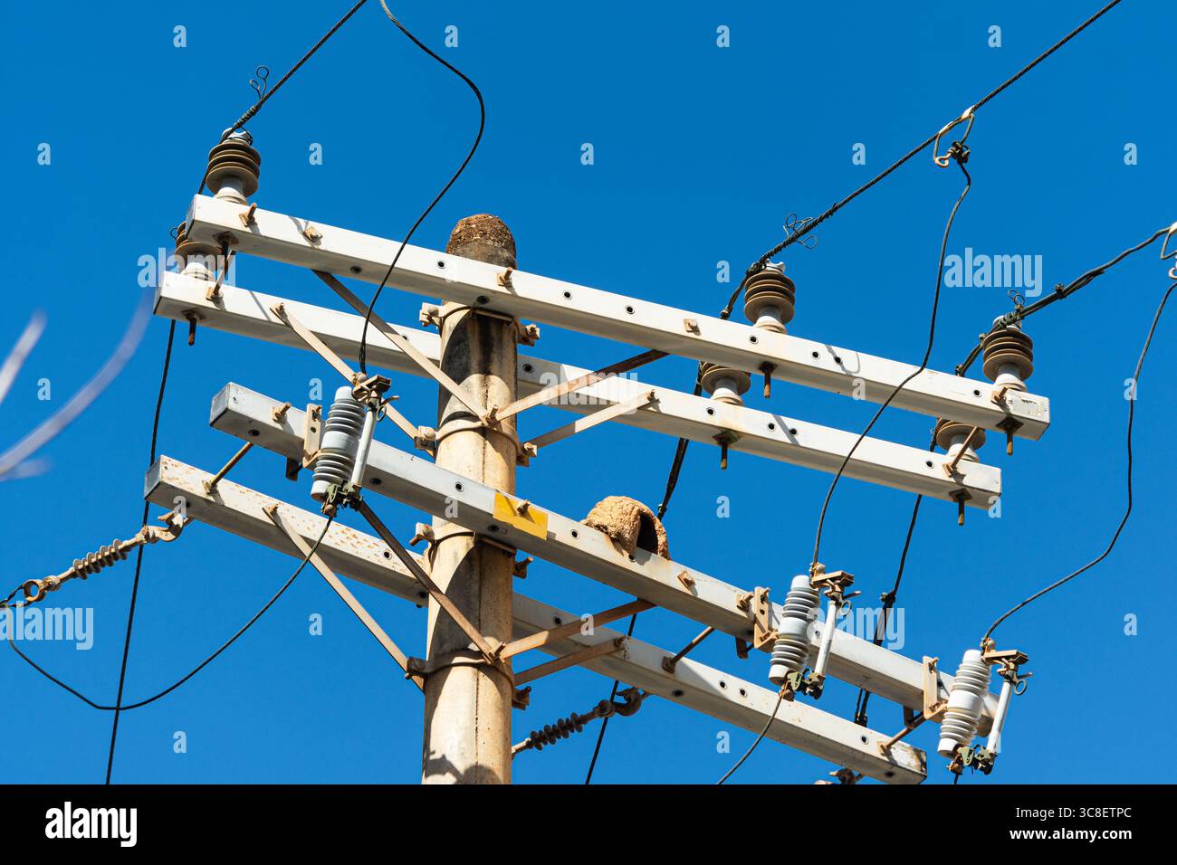 The top of a power pole with a tangle of electrical, internet, and ...