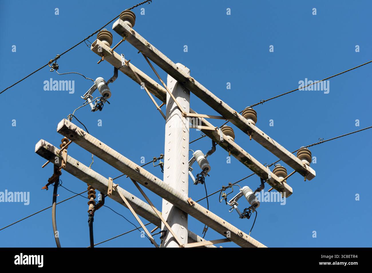 The top of a power pole with a tangle of electrical, internet, and ...