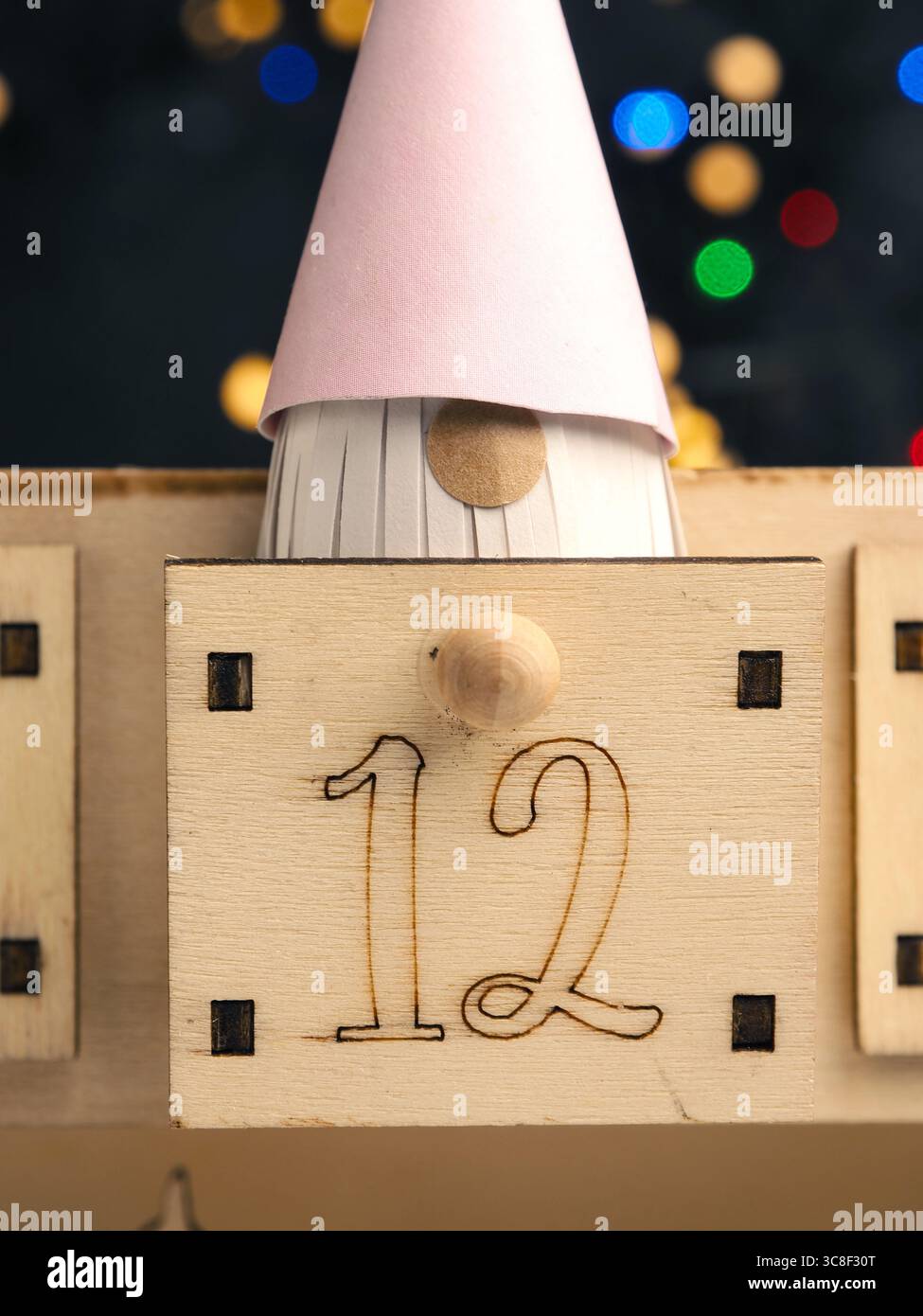 Advent December wooden drawer number twelve with paper gnome on blurred ...