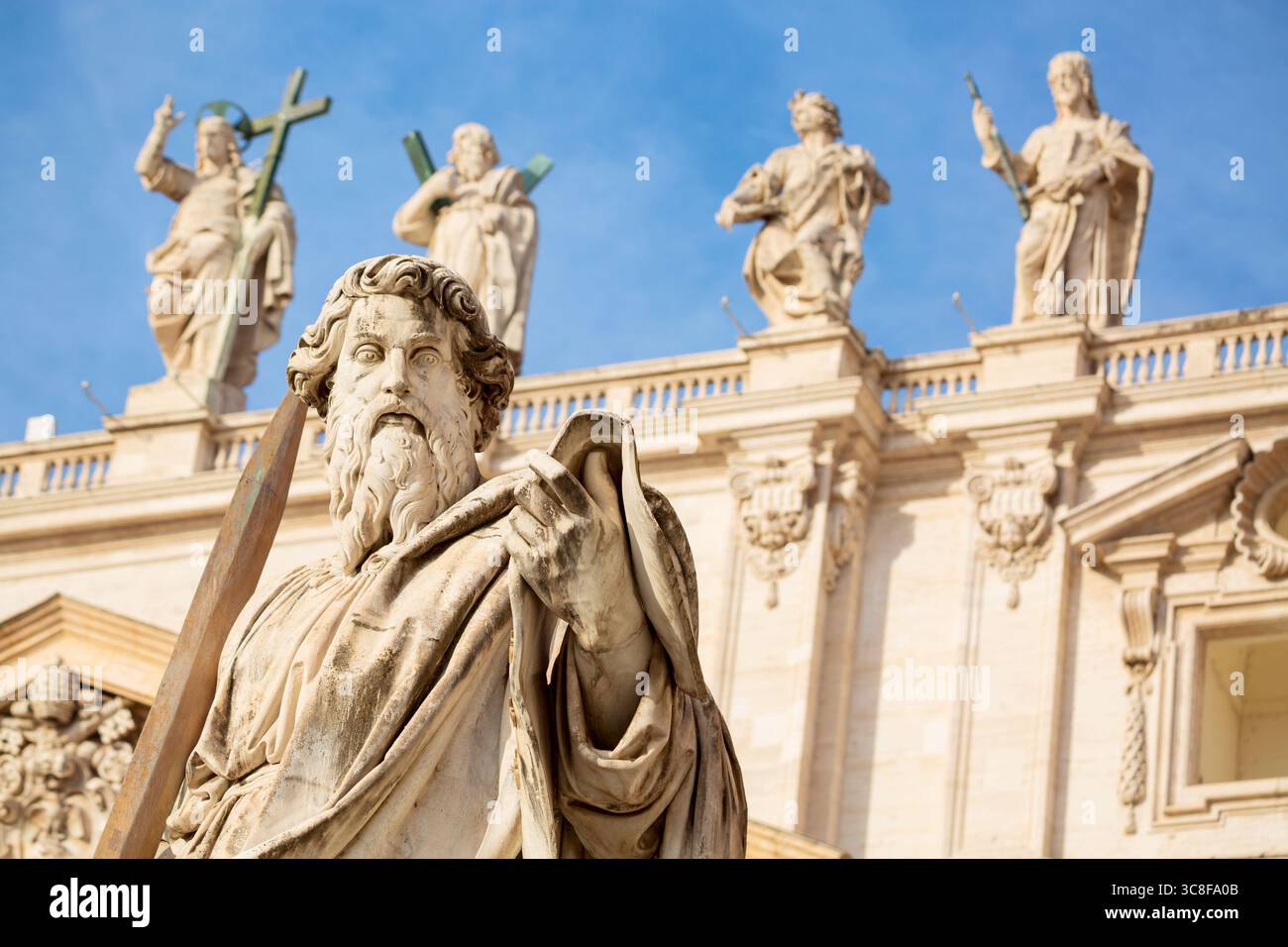 Statue of Apostle Paul with a sword in front of the St Peter's Basilica ...