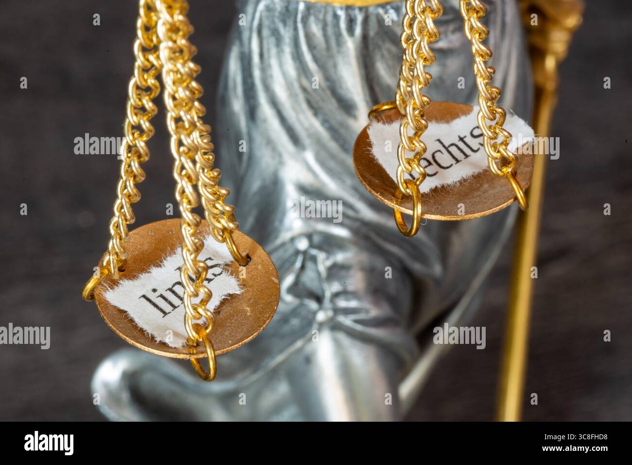Symbolic image: Close-up of the scales of Justice with two torn leaves ...